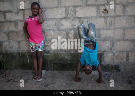 Monrovia, Liberia. 30th May, 2018. A man sifts through rubbish looking ...