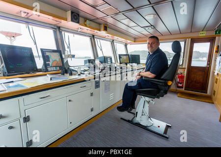 Captain Mike Smith of the NLB buoy tender 'Pole Star' on the bridge ...