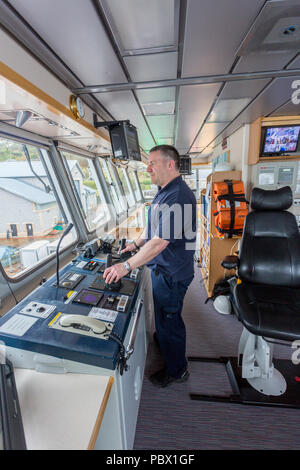 Captain Mike Smith of the NLB buoy tender 'Pole Star' on the bridge ...