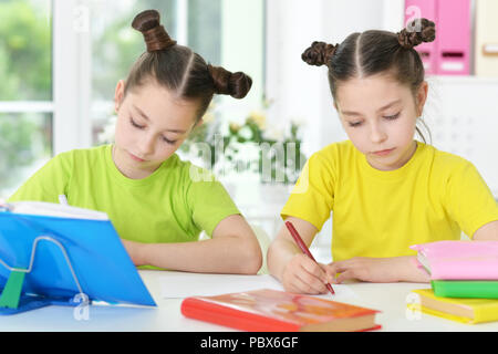 two sisters twins doing homework Stock Photo - Alamy