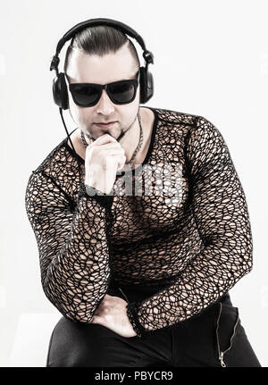 emotional and charismatic DJ - rapper with headphones on a light Stock ...