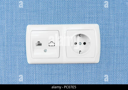 Socket on a blue wall, a multifunction outlet with an internet ...
