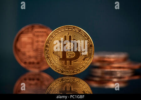 Cryptocurrency. Bitcoin virtual money. Golden coin on the wooden table ...