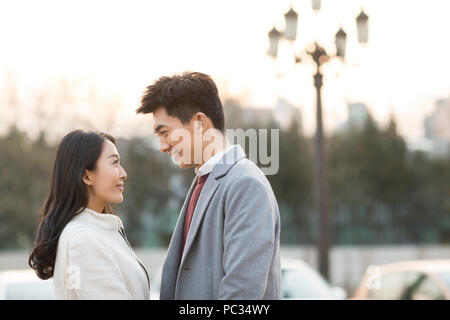 Cheerful young Chinese couple dating Stock Photo - Alamy