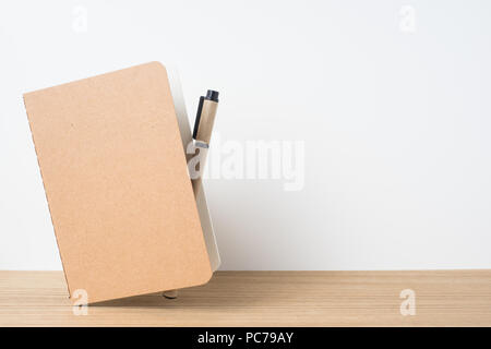 White notepad with brown pen on soft beige background. Minimal 3d ...