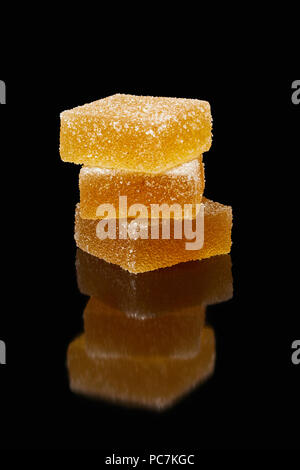 closeup view of stack of jelly candies isolated on black background ...