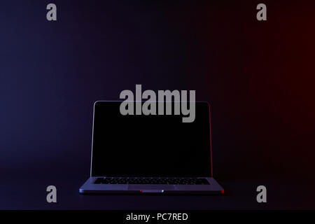 one turned off laptop with blank screen on dark Stock Photo - Alamy