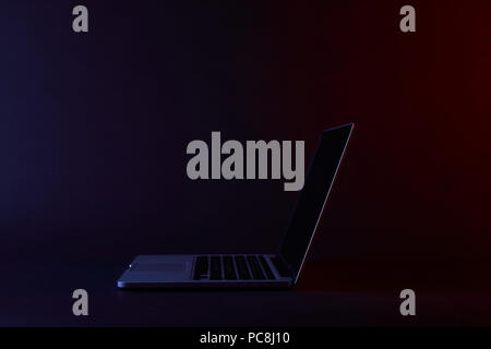 one open laptop with reflecting screen on dark surface Stock Photo - Alamy