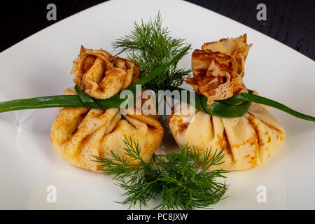 Delicious pancake bag with chicken Stock Photo - Alamy
