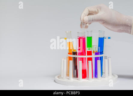 Experiments in mixing chemical substances into glass tubes with a ...