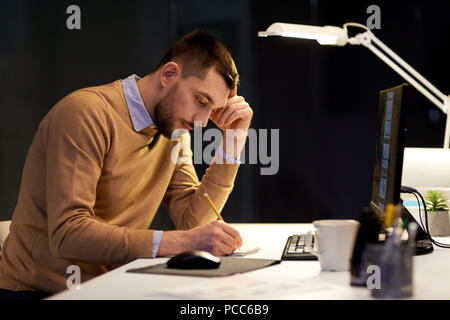 Hispanic man with beard working at the office with laptop at night ...
