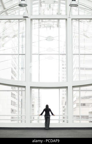 Businesswoman standing in the lobby of a large business center Stock ...