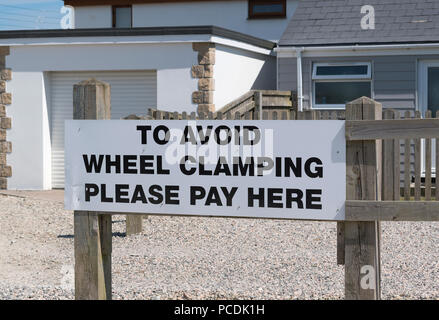 A wheel clamping warning sign on a wall in . Photo by Gordon Scammell ...