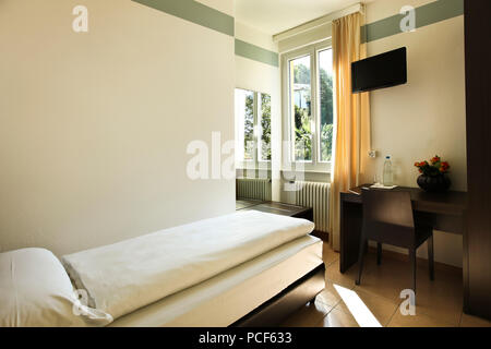 Simple hotel room, single bed Stock Photo - Alamy
