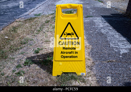 A Frame safety sign warning of drone operators filming. The sign reads ...
