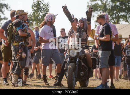 Wacken, Germany. 02nd Aug, 2018. Four festival visitors in unicorn ...