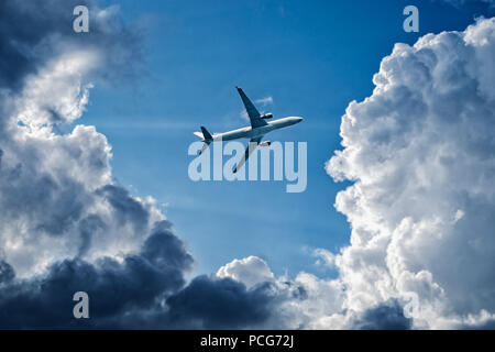 A plane flies into storm clouds and rain over the Fraser River and the ...