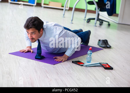 Employee doing exercises during break at work Stock Photo - Alamy