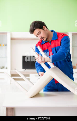 Repair contractor repairing broken chair at home Stock Photo - Alamy