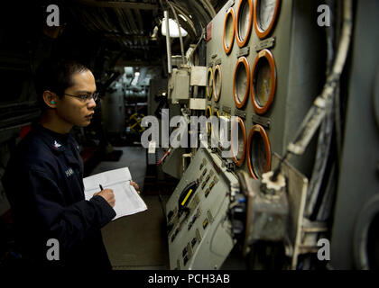 US Navy Engineman 3rd Class autographs a soccer ball at the Iram ...
