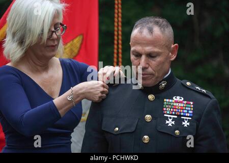 Jean Kilker, wife of Maj. Gen. Daniel J. Lecce, shakes hands with the ...