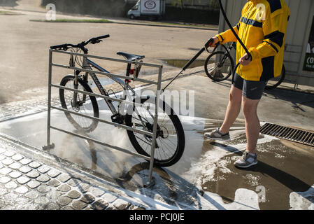 young man washing bicycle at carwash. lifestyle Stock Photo - Alamy