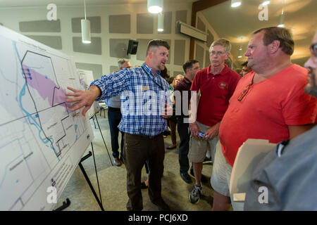 Parchment, Michigan – Residents examine a map showing the extent of ...