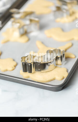 Unfinished unicorn shape sugar cookies on the baking sheet Stock Photo ...