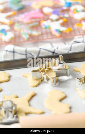 Unfinished unicorn shape sugar cookies on the baking sheet Stock Photo ...