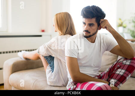Young couple worried for pregnancy test results. Sitting on the table ...