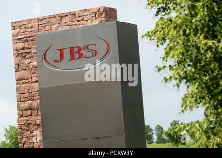 A logo sign outside of the headquarters of JBS USA Holdings, Inc., in ...