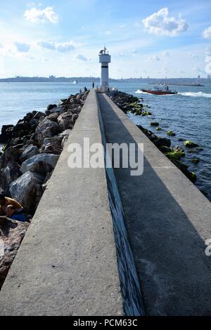 People hanging around Kadikoy Lighthouse on a sunny day and the ...