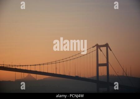 Bosphorus Bridge silhouette early in the morning while the sun is ...