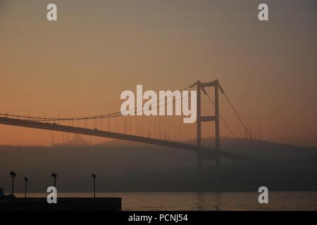 Bosphorus Bridge silhouette early in the morning while the sun is ...