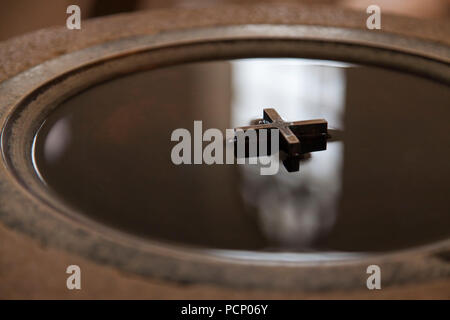 Sign at a holy water font in a Roman Catholic chapel "Public health ...