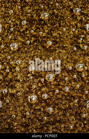 Gold Christmas tree balls on a deep red backdrop Stock Photo - Alamy