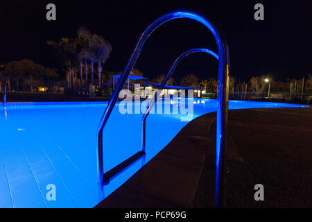 Luxury swimming pool glowing in blue light at night Stock Photo - Alamy