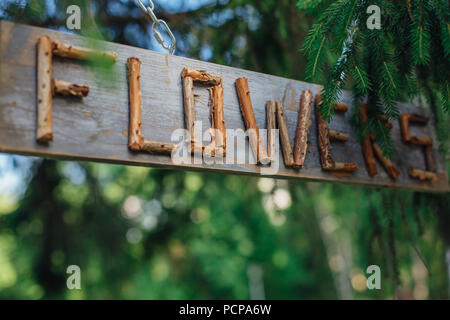 Word FLOWERS made of dry branches on the wooden sign Stock Photo - Alamy