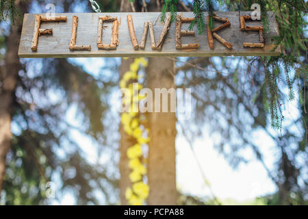 Word FLOWERS made of dry branches on the wooden sign Stock Photo - Alamy