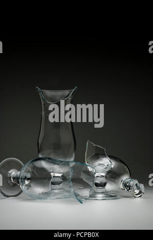 Broken cup on blue table with white pieces nearby Stock Photo - Alamy