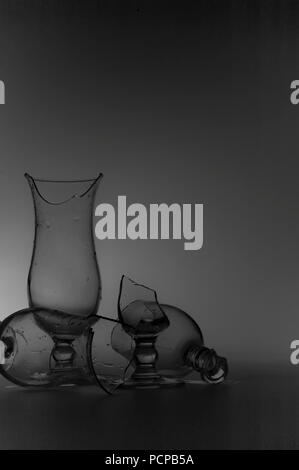 Dangerous still life with three empty modern broken / shattered glasses ...