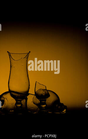 Dangerous still life with three empty modern broken / shattered glasses ...