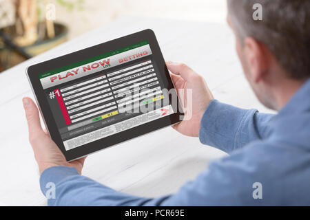 Sport bet addicted man betting at home Stock Photo - Alamy
