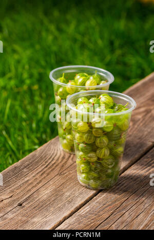 fresh gooseberry in plastic containers on the table Stock Photo - Alamy