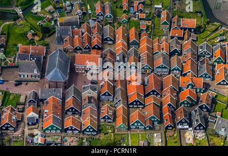 Marken island, with small fisherman's houses and the town church, red ...