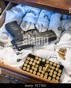 Semi-automatic pistol in sock drawer, USA Stock Photo - Alamy