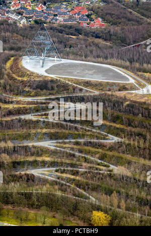 A birds eye view shot of a serpentine road leading through mountain ...