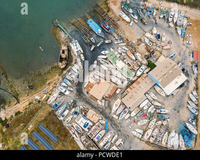 Aerial view of shipyard with ships in docks, cranes and warehouses ...