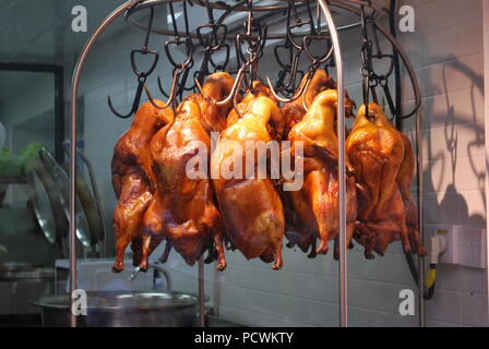 Window display of Peking crispy duck hanging air drying in Chinese ...