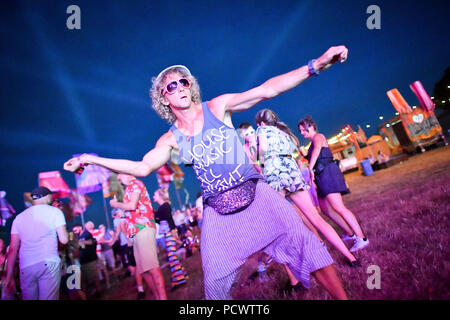 Revelers dance in the Temple Field at Bestival at the Lulworth Estate ...